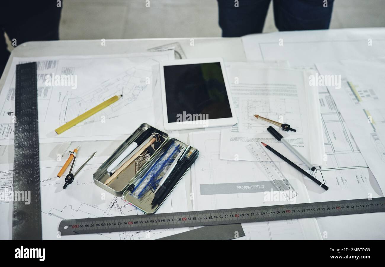 Lets get building. various tools and a blueprint on a table at a ...
