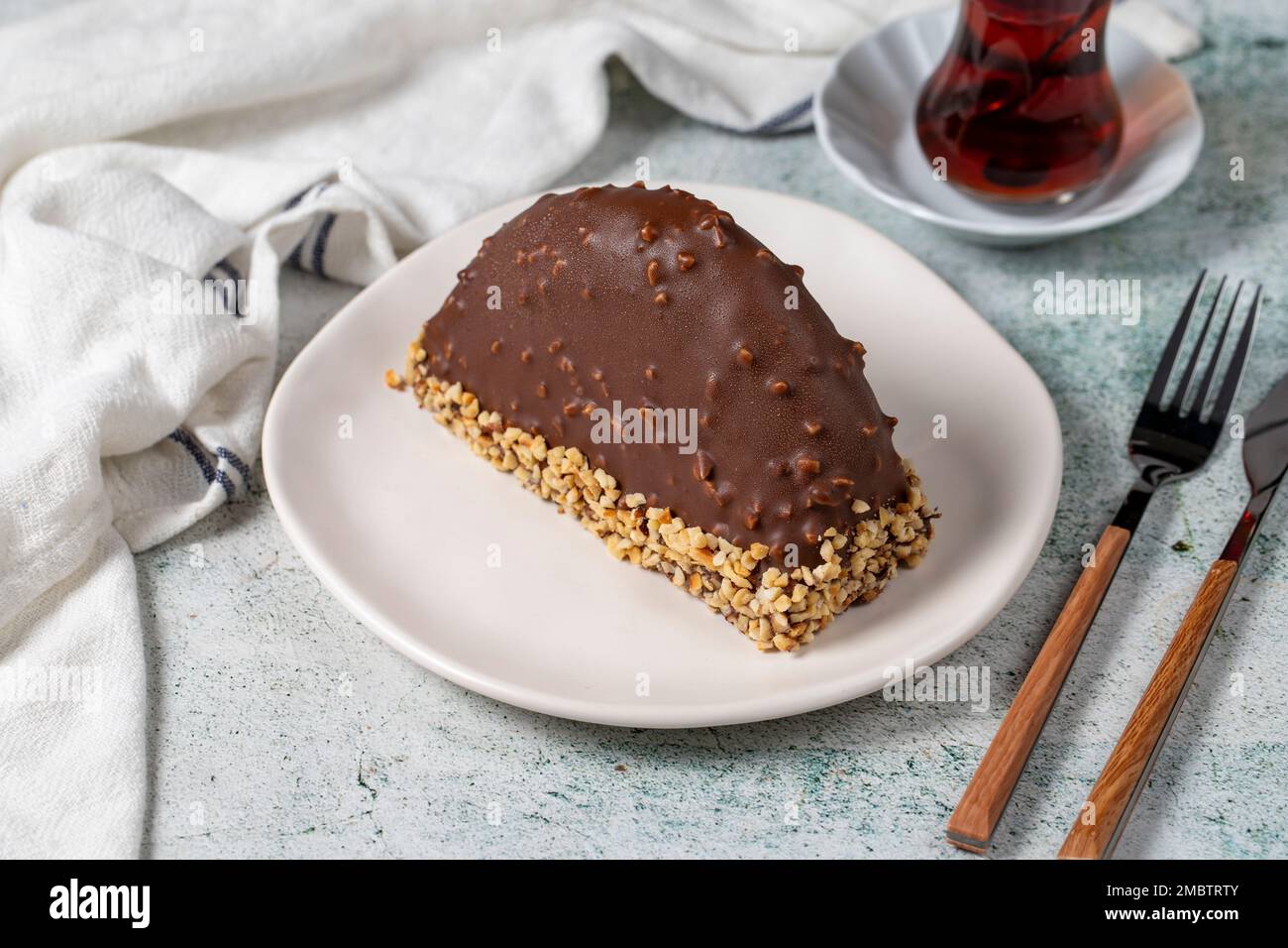 Chocolate Banana Cake. Malaga cake with banana inside, chocolate and hazelnut outside on a stone ...
