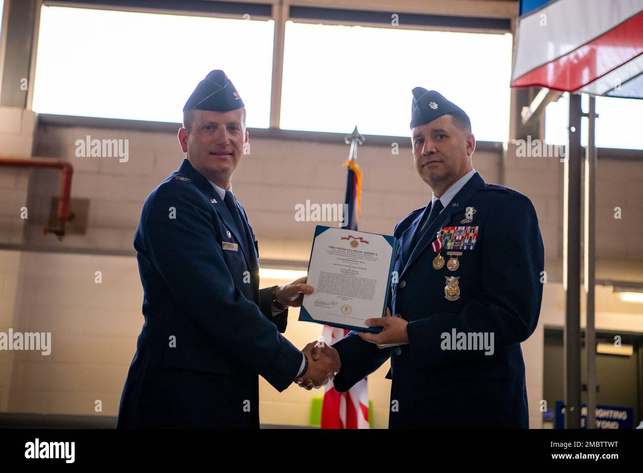 U.S. Air Force Col. Richard Martin, left, 423d Air Base Group commander, presents the ...