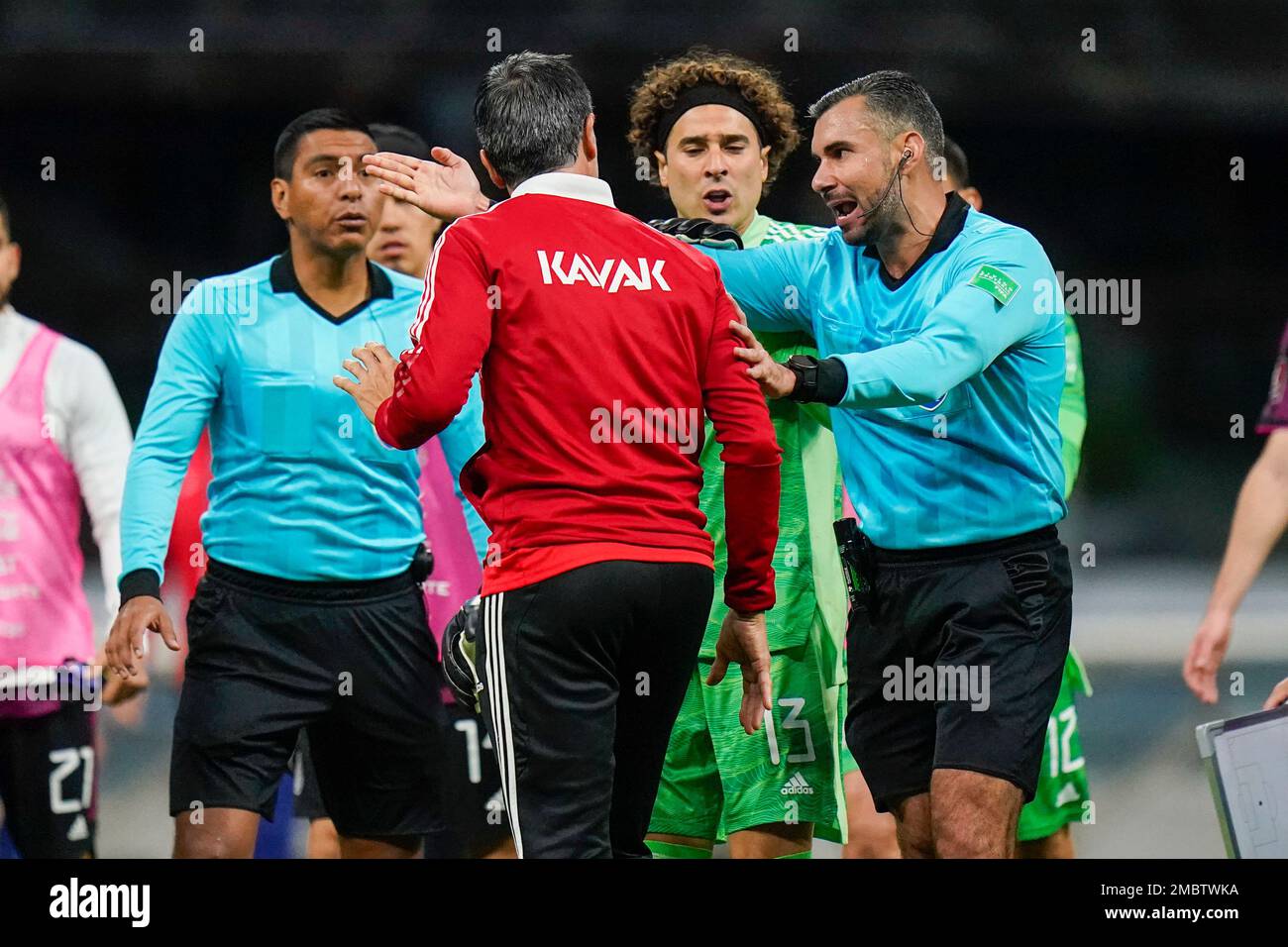Referee Mario Escobar from Guatemala, right, talks to a Mexico's team ...