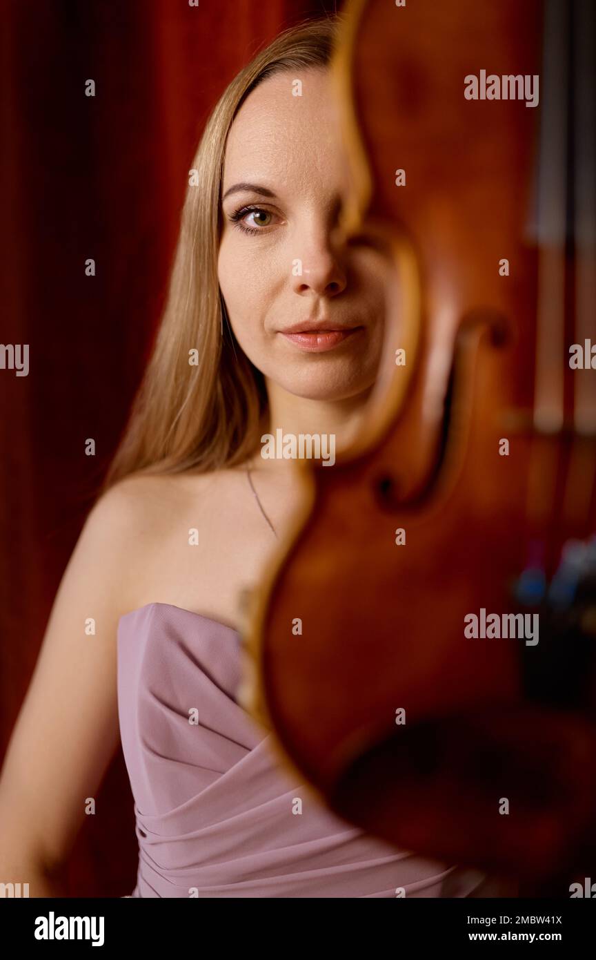 Lady holding stringed instrument hi-res stock photography and images - Alamy