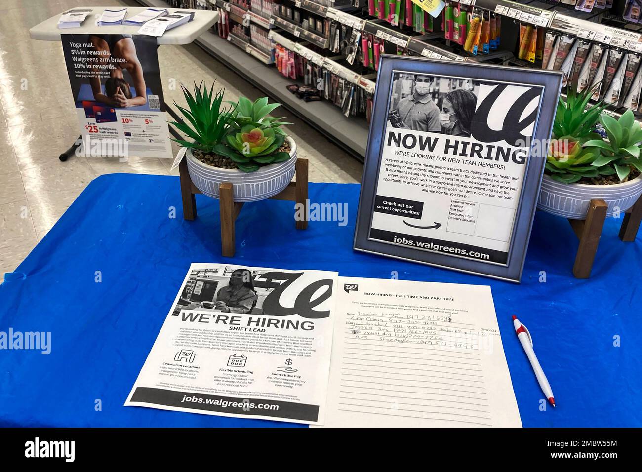 Hiring information papers are seen on a table at Walgreens, Saturday ...