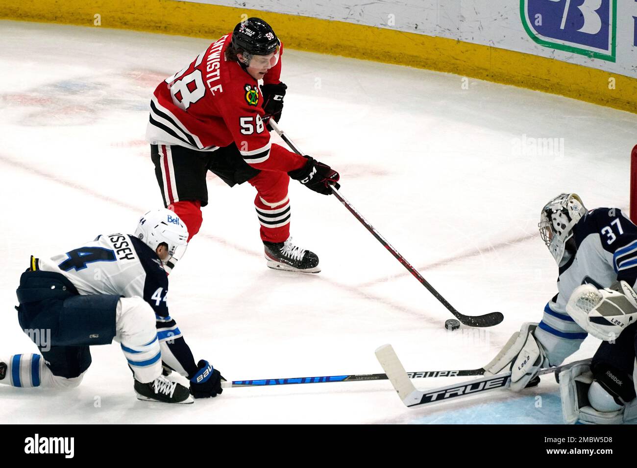 Chicago Blackhawks right wing MacKenzie Entwistle (58) try to shoot ...
