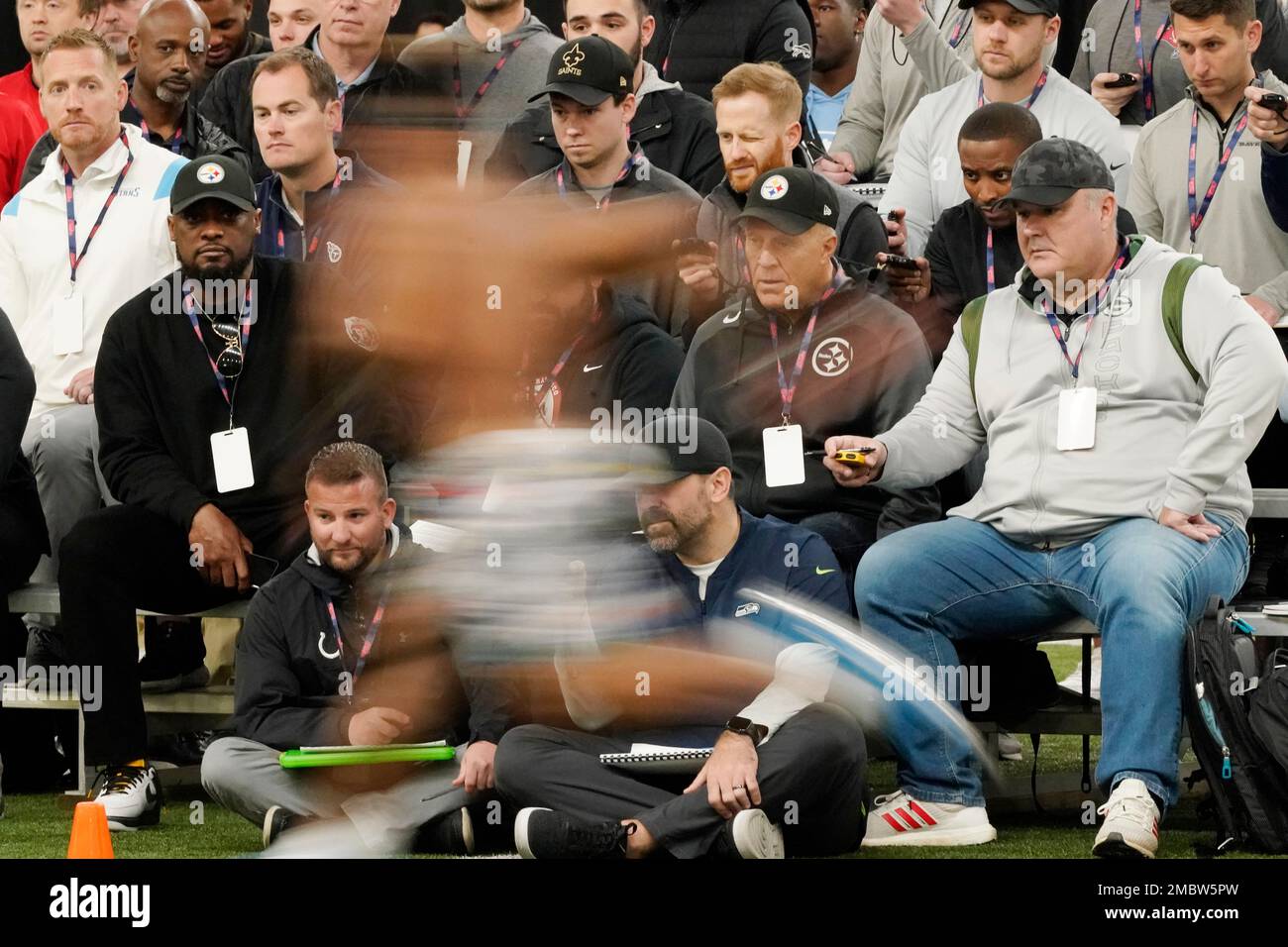 Pro football scouts and coaches time players as they sprint through the ...