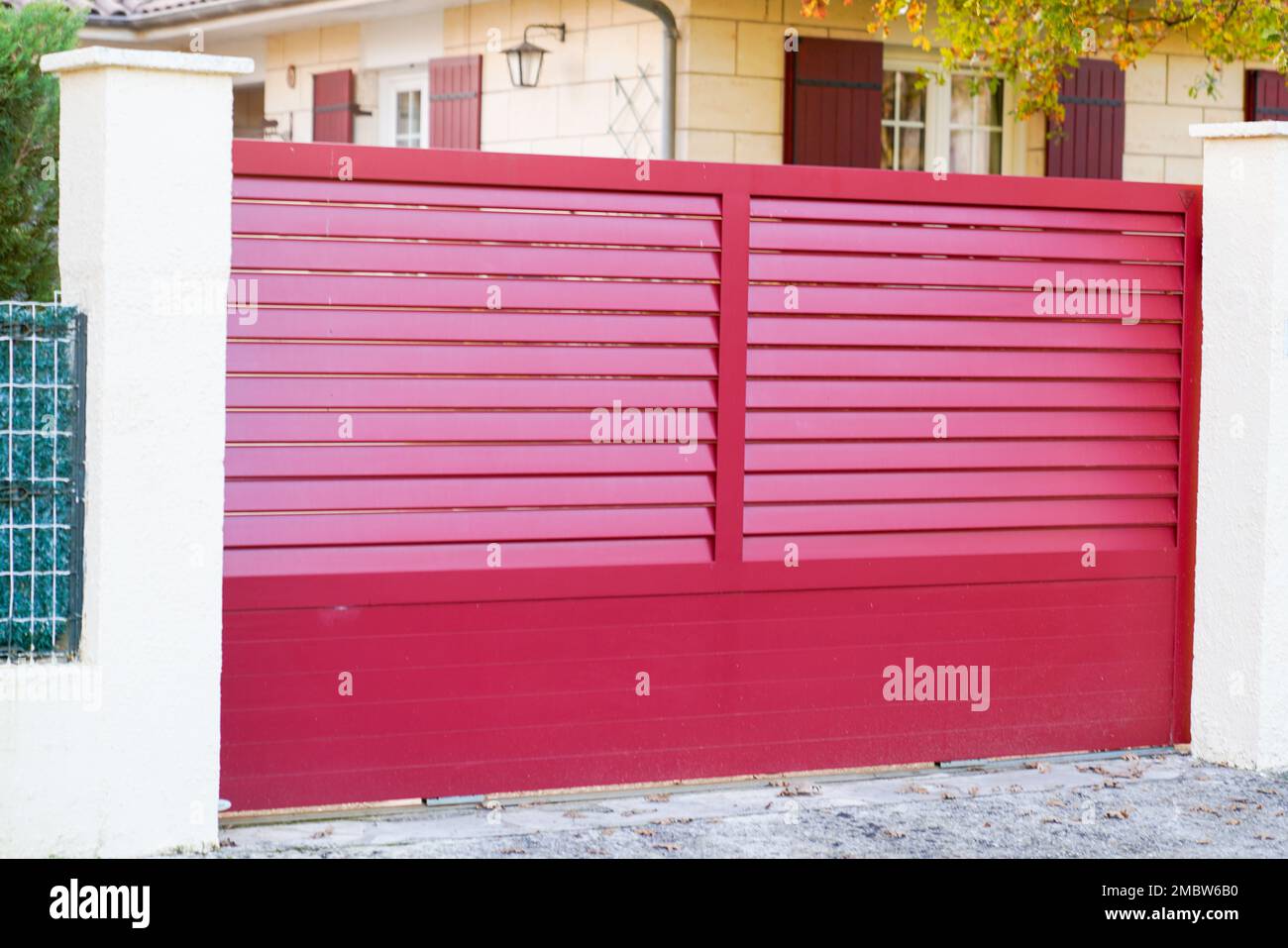 portal steel big red metal gate fence on modern house street Stock ...