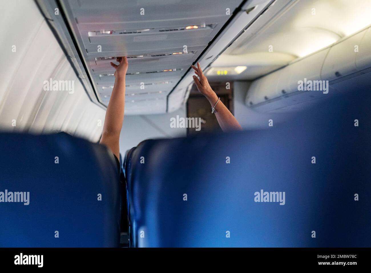 Passengers adjust air vents on board a Southwest airplane during a ...