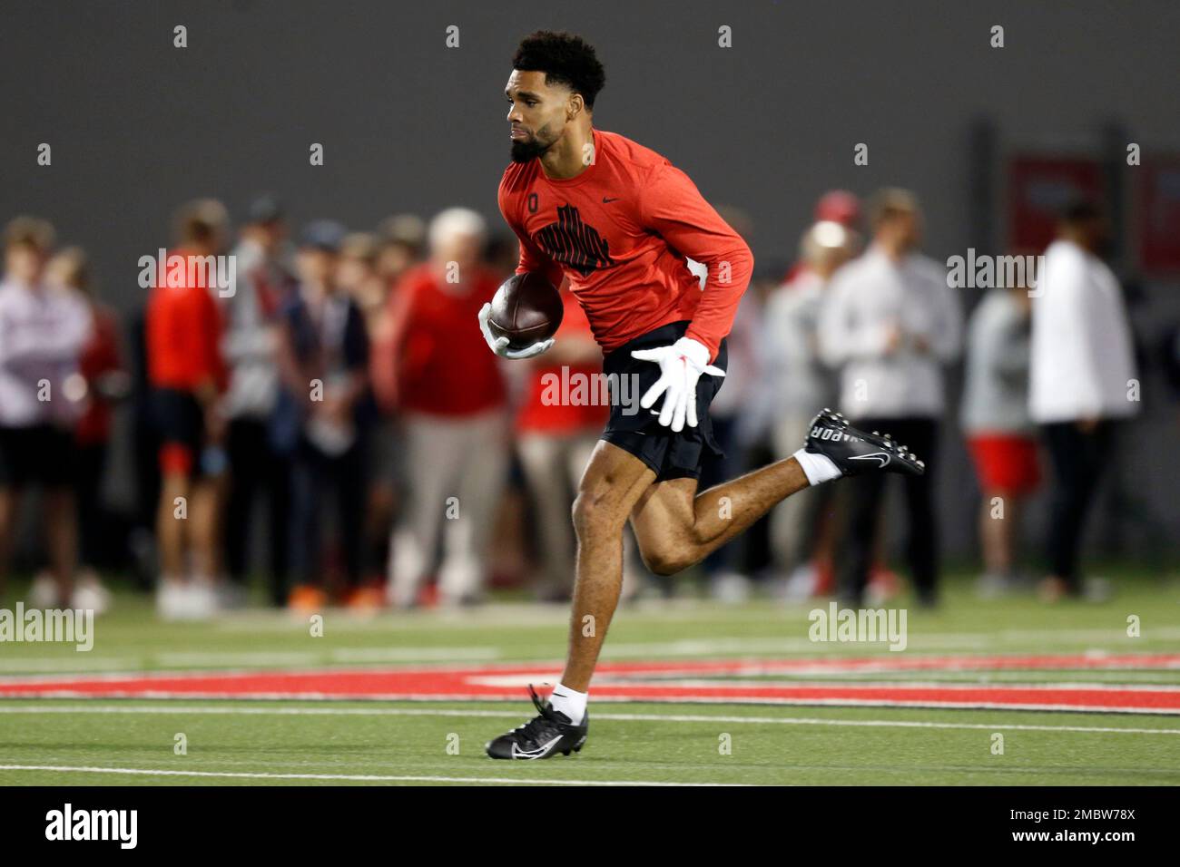 Wide receiver Chris Olave runs a football drill during Ohio State Pro ...