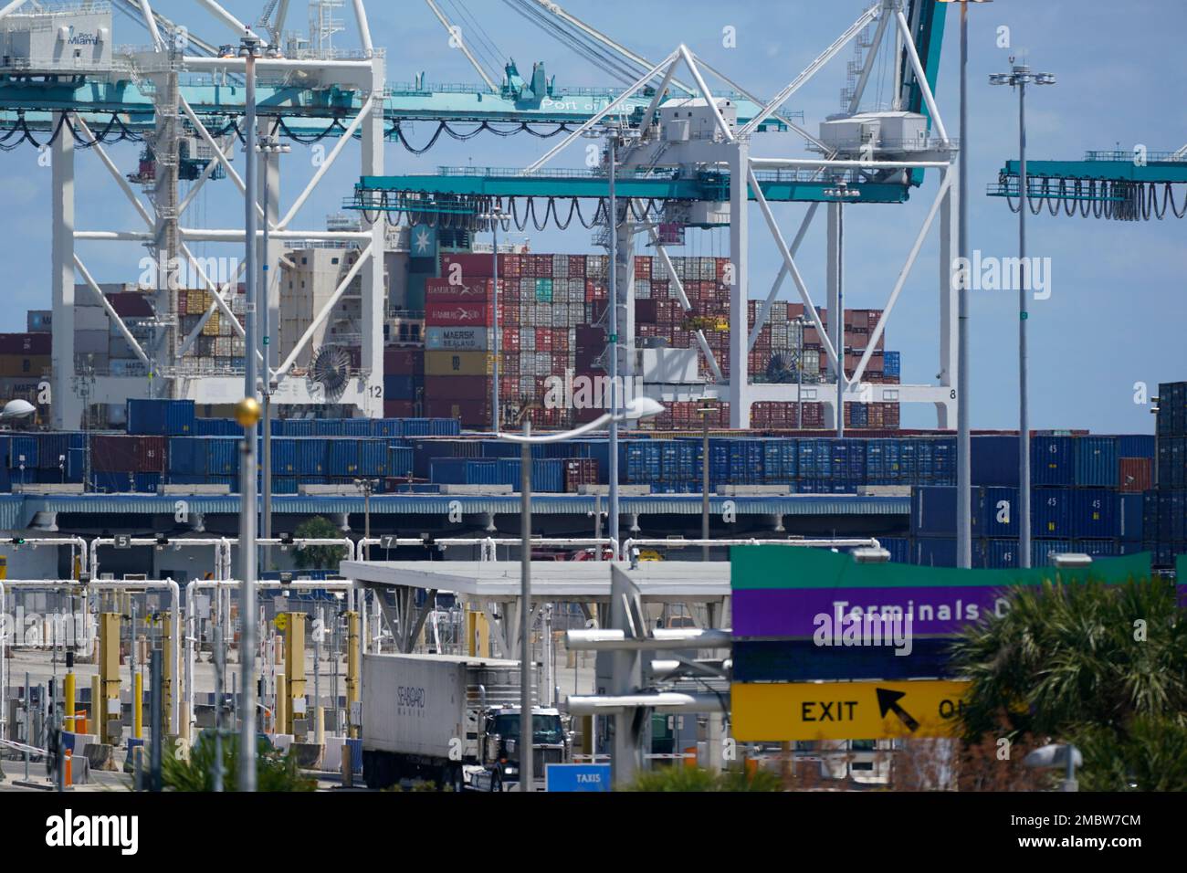 Cargo containers are shown stacked near cranes at PortMiami, Friday ...