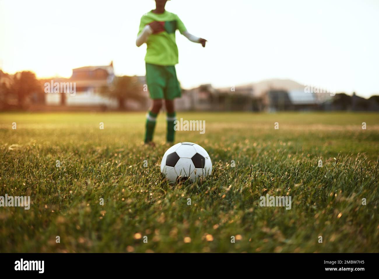 Shoot for your goals. Closeup shot of a young boy playing soccer on a ...