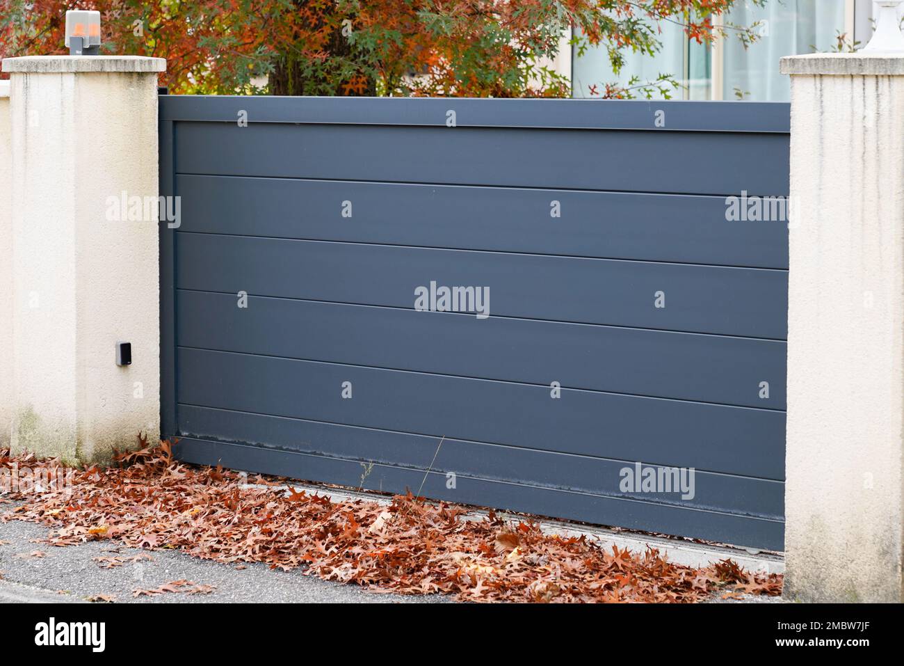 Aluminum gray metal sliding modern gate of suburb house Stock Photo - Alamy
