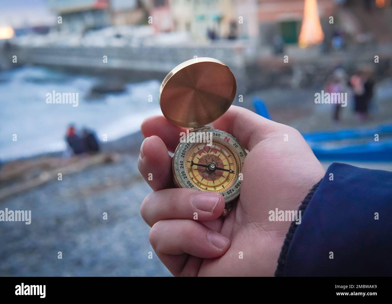 close up of golden compass in hand,streetb background Stock Photo - Alamy