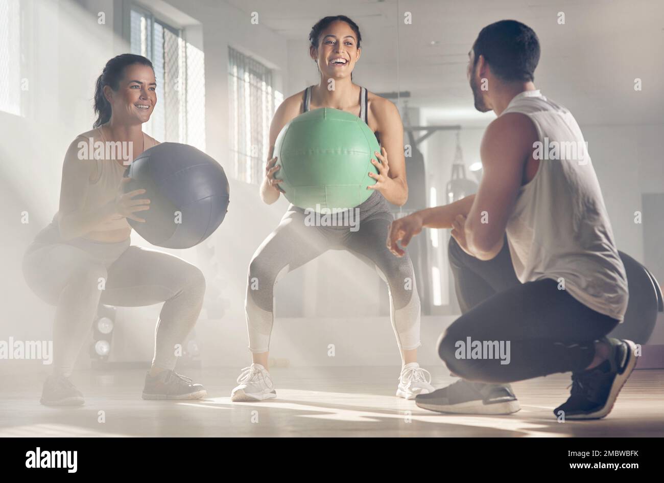 Hes here to help us reach our fitness goals. two women using fitness ...
