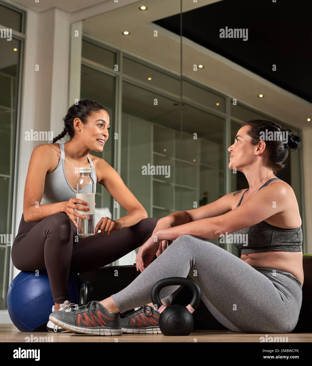 Catching up after their workout. Full length shot of two attractive ...