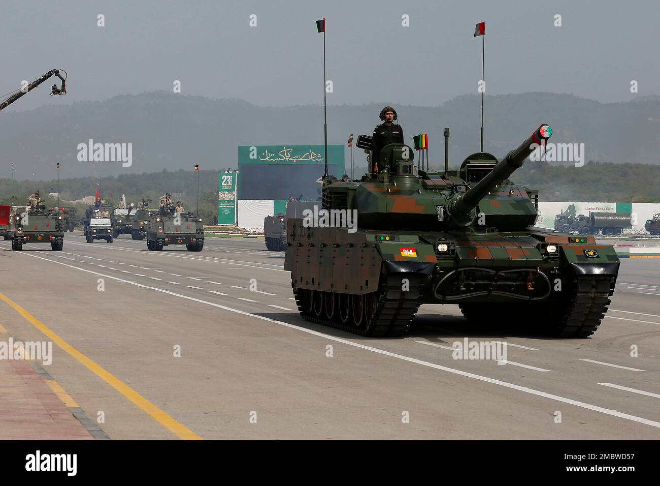 A Pakistani-made tank and other military vehicles roll down during a ...