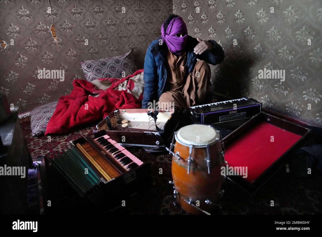 Zabiullah Nuri, 45, covers his face to protect his identity, as he ...