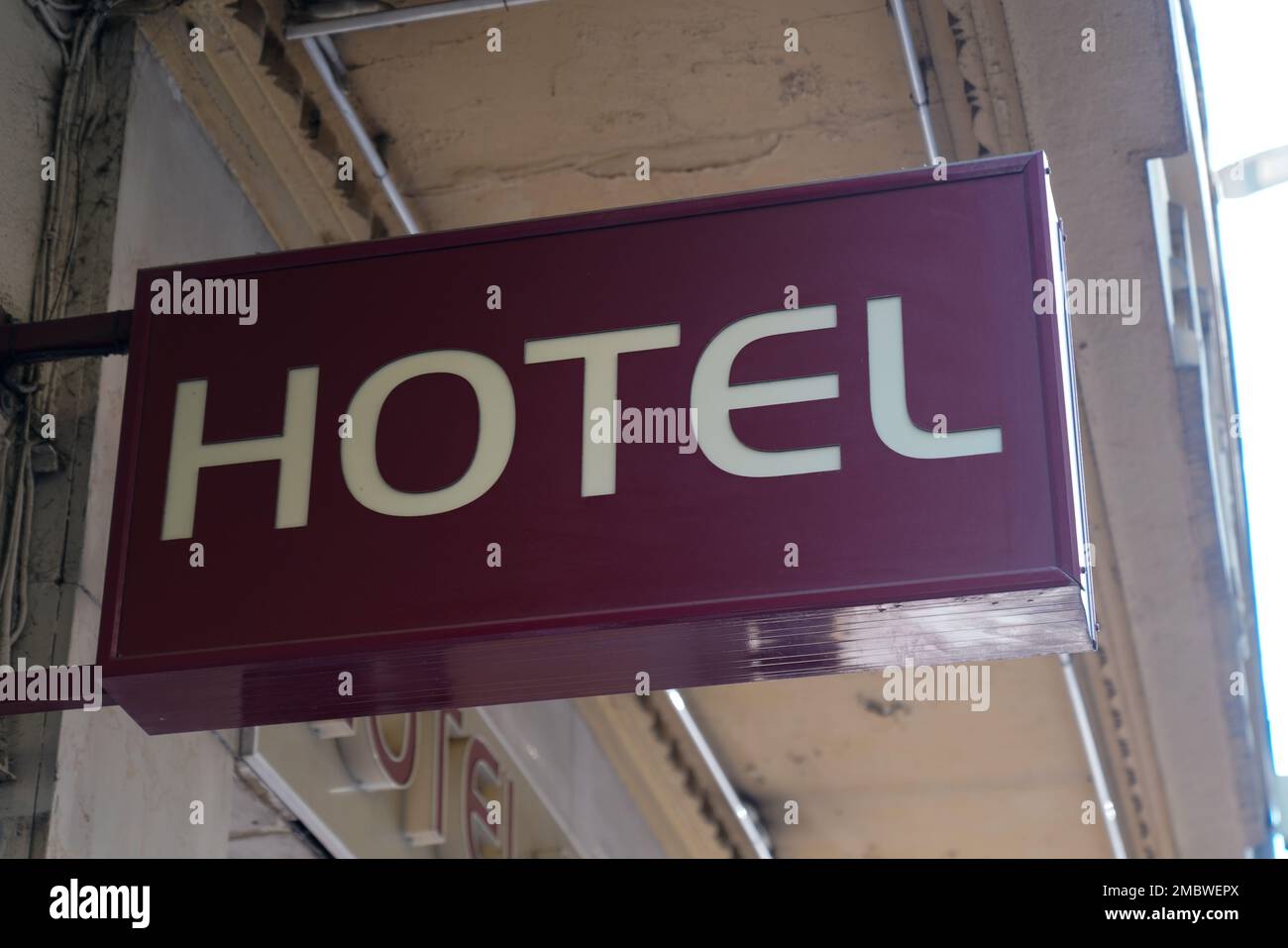 Hotel sign text in wall building facade in tourist city Stock Photo - Alamy