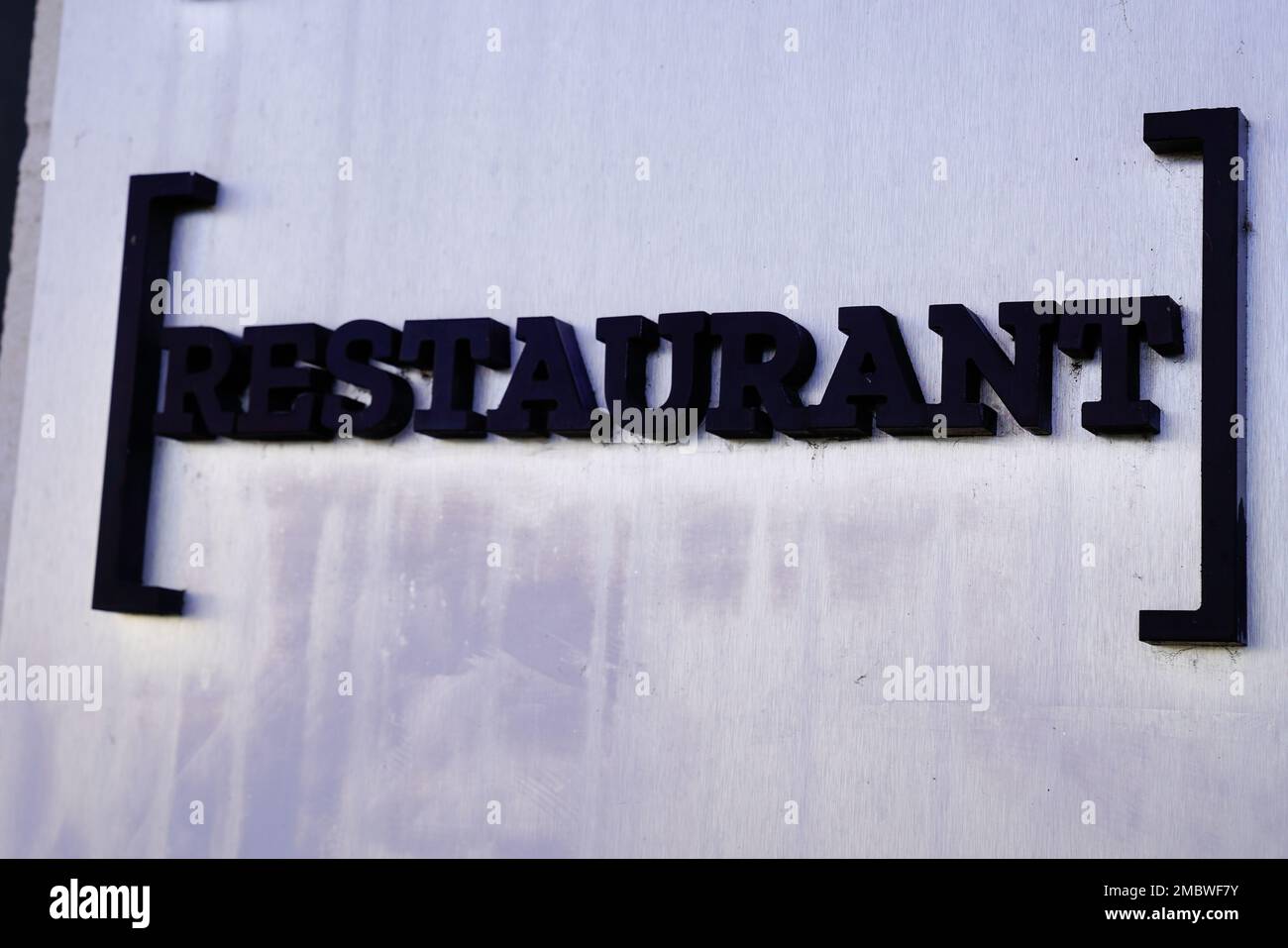 restaurant text sign on wall facade entrance in street Stock Photo - Alamy