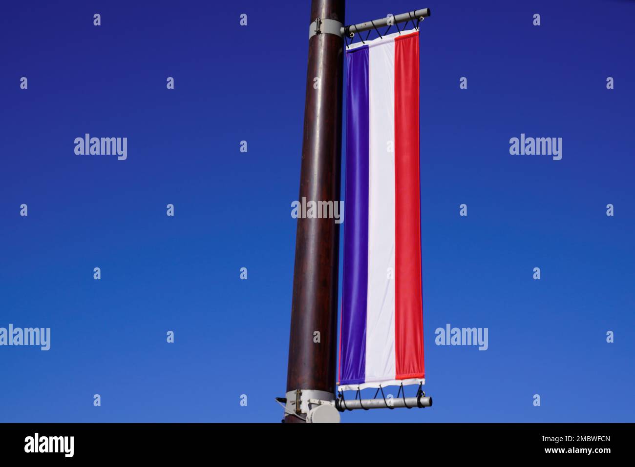 france flag hanging from a long mast in front of a blue sky Stock Photo ...