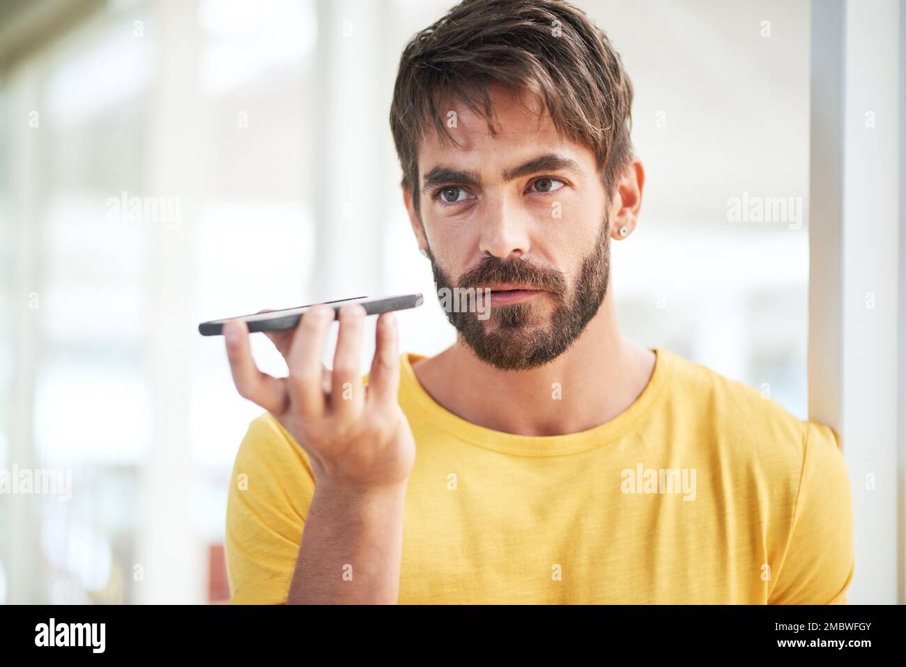 Please press one to retrieve your voice message. a young businessman ...