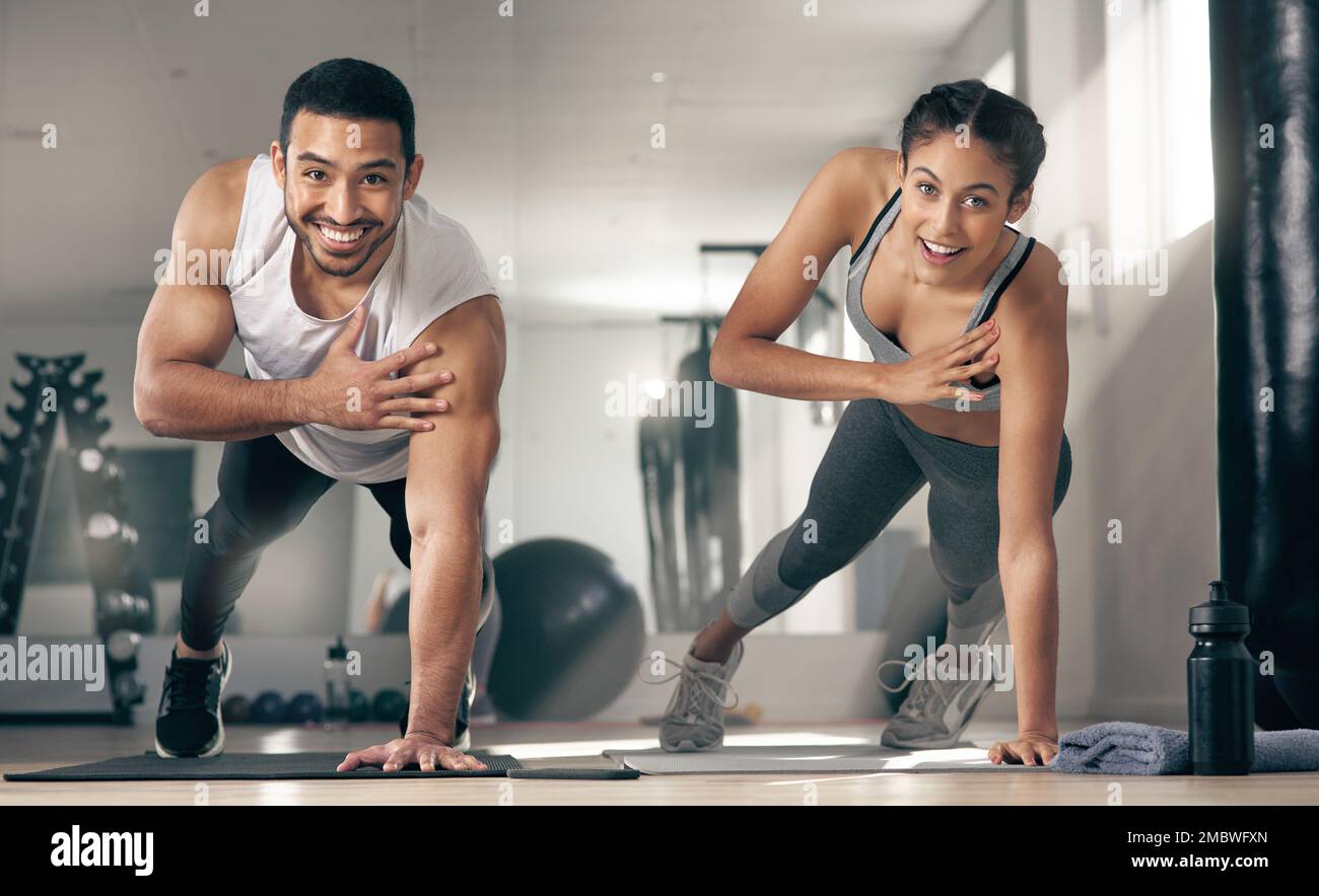Partner up and make working out fun. two young athletes working out ...