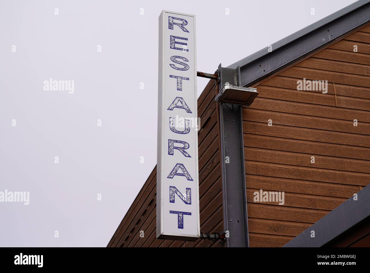 restaurant text sign grey on wall facade building city street ...