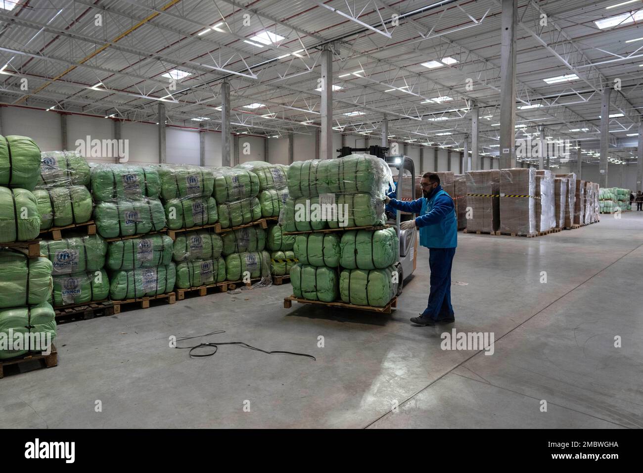 FILE - UNHCR staff load a truck with supplies for Ukraine in an aid ...