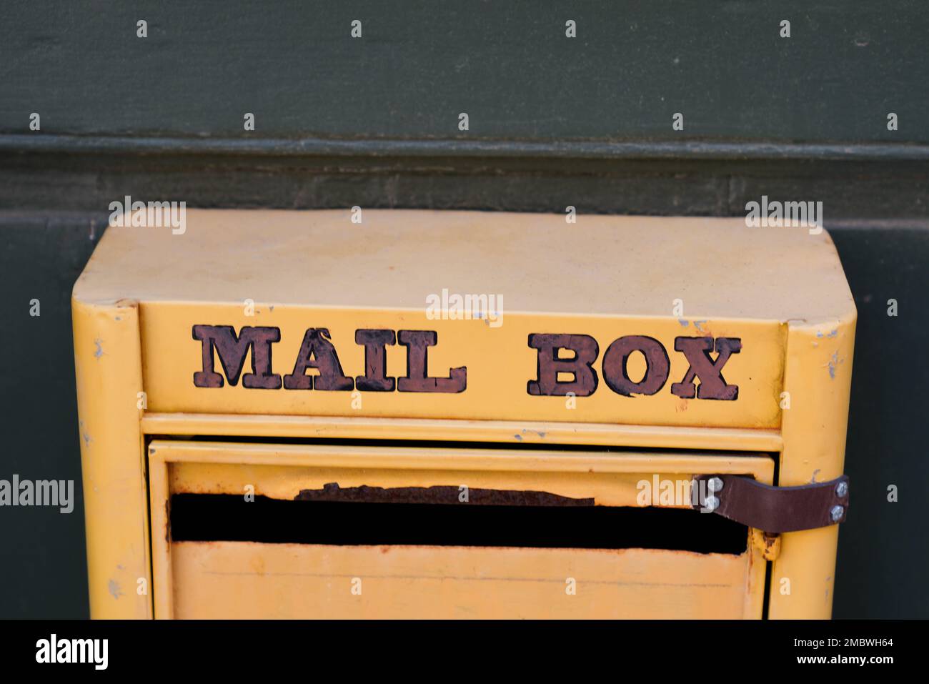 Vintage ancient yellow mail post box on home wall old mailbox Stock ...