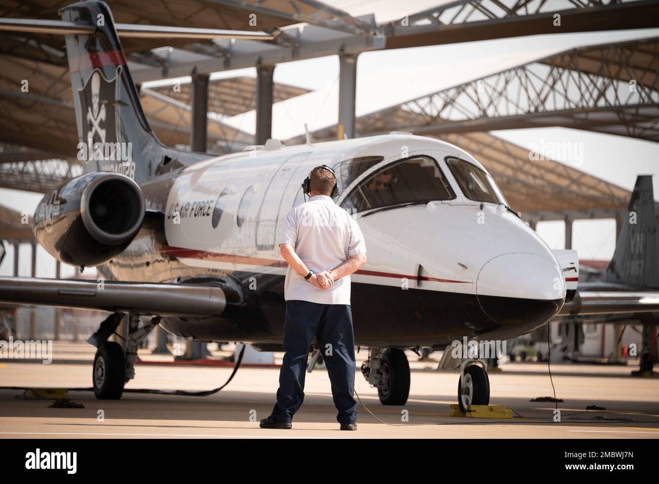 Randy Hutchcraft, a T-1A Jayhawk flightline mechanic, guides the pilots ...