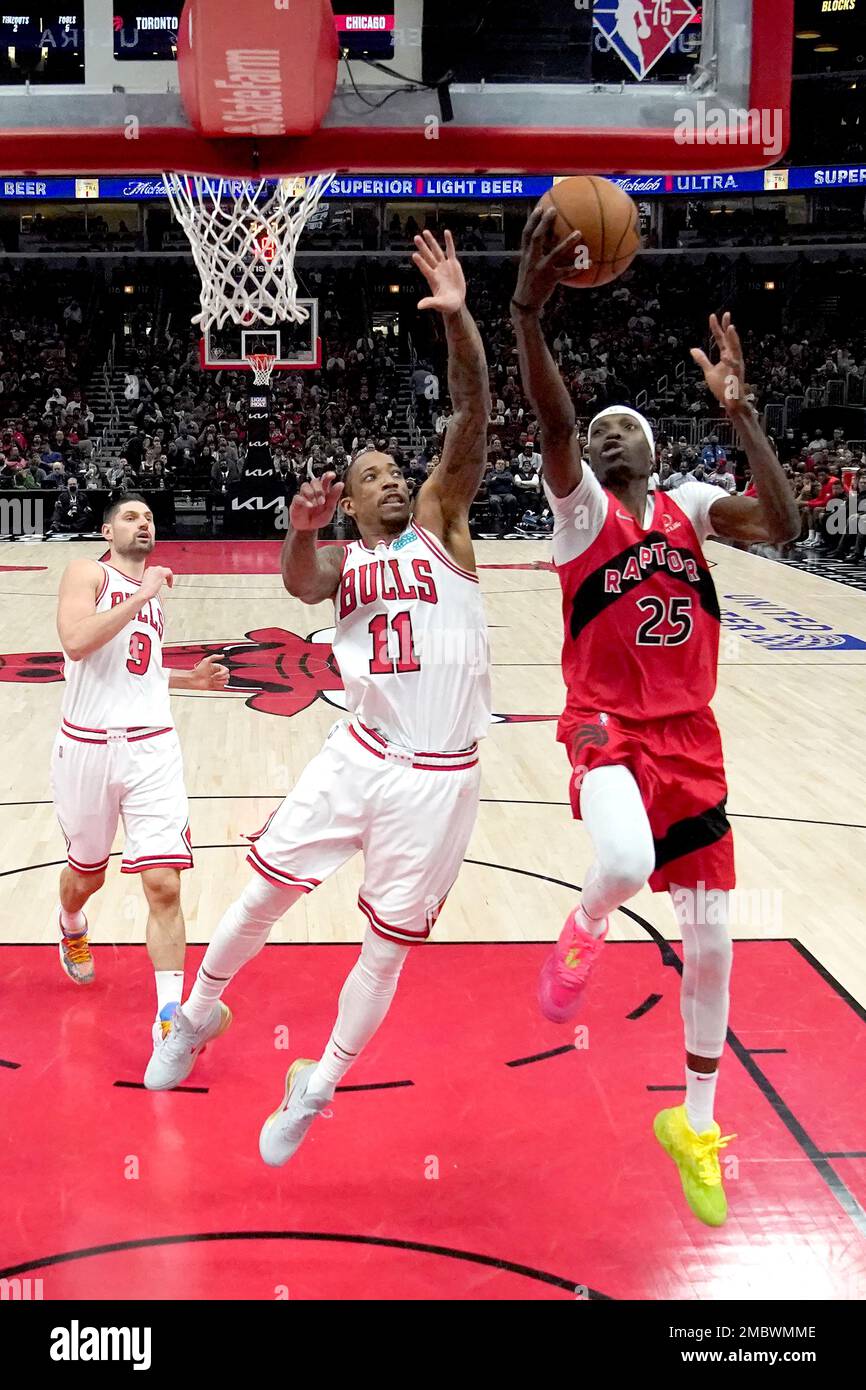 Toronto Raptors' Chris Boucher (25) scores past Chicago Bulls' DeMar ...