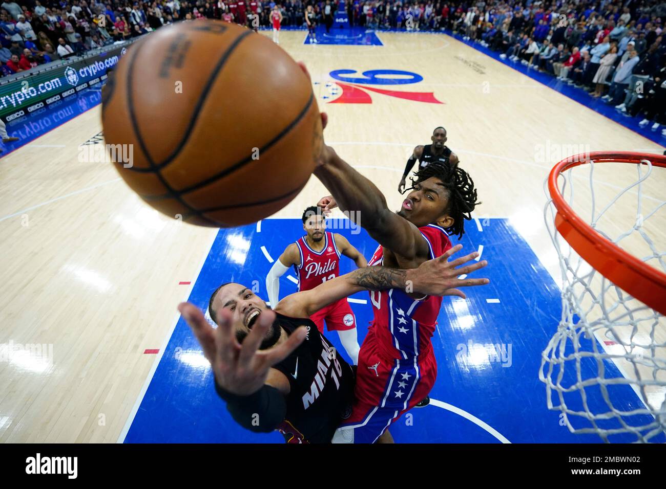Philadelphia 76ers' Tyrese Maxey, right, blocks a shot by Miami Heat's ...