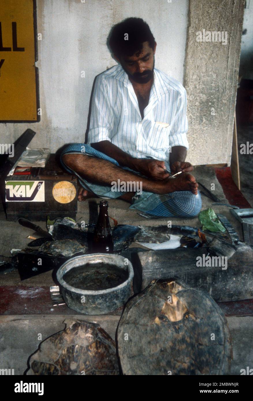 Man in Sri Lanka carving items from turtle-shell for sale to tourists ...