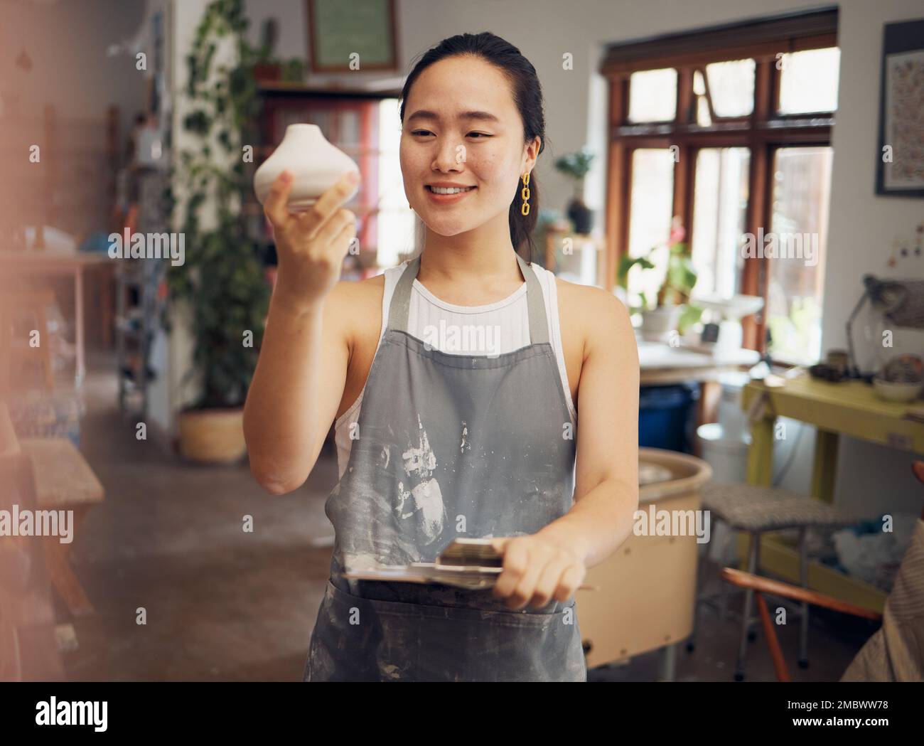 Creative, art and woman in workshop with clay pot, ceramics and pottery ...