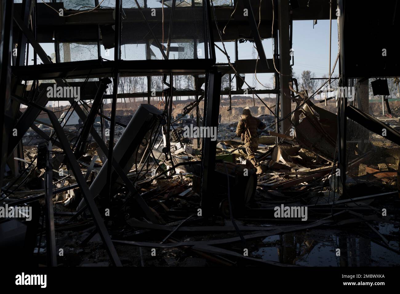A Ukrainian serviceman walks among debris inside a shopping center ...