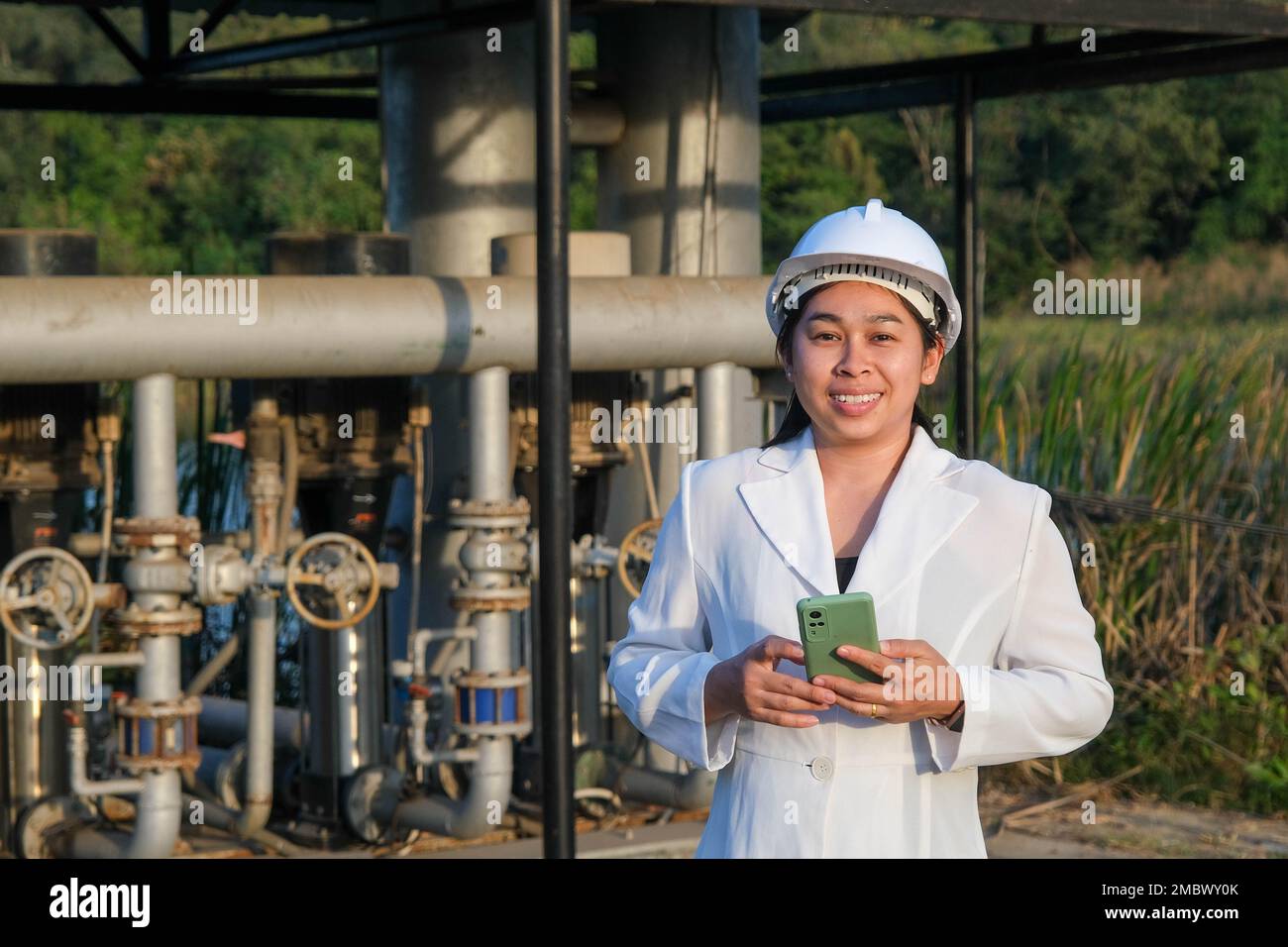 Environmental engineer in white helmet working at wastewater treatment ...