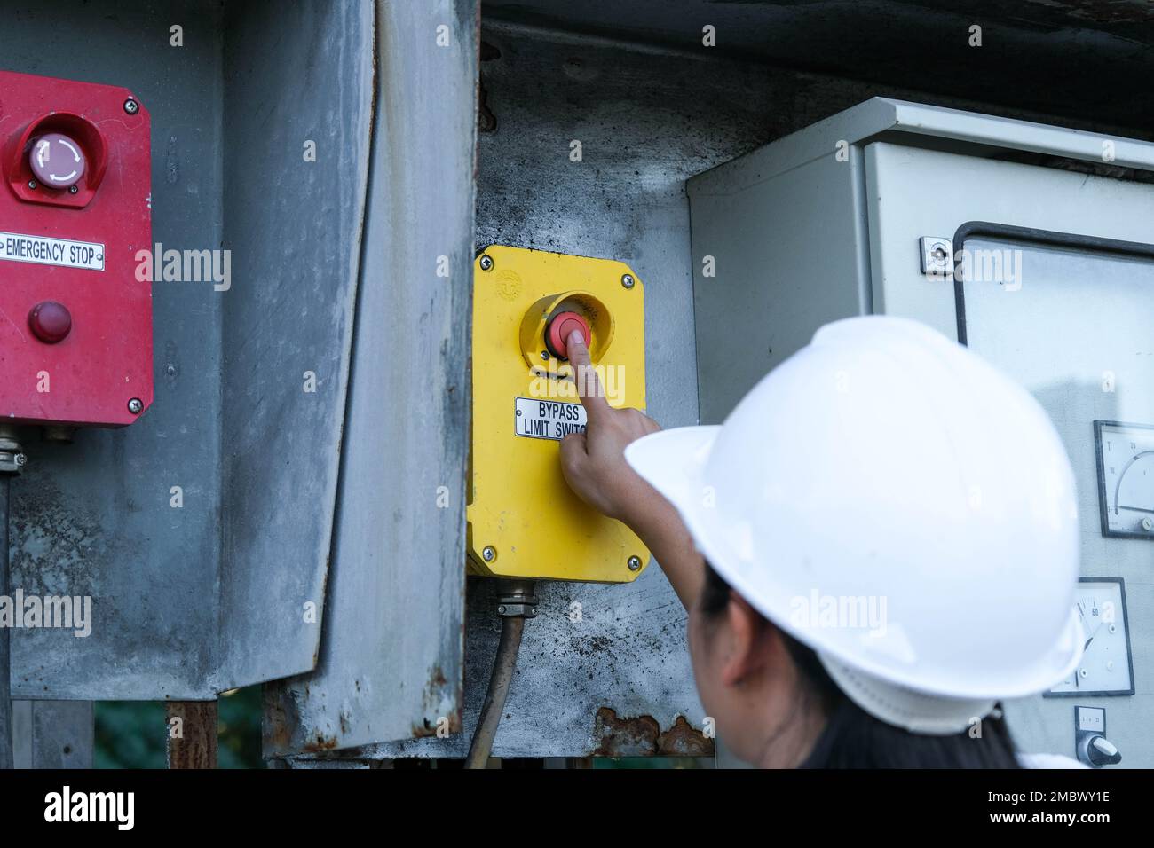 Portrait of professional Asian electrical engineer turning on the ...