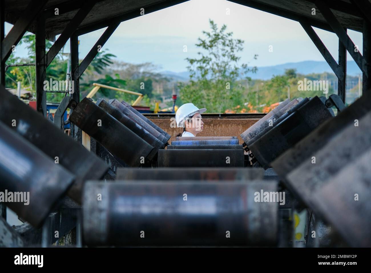 Mining engineer wearing a white helmet surveying her work place Stock ...