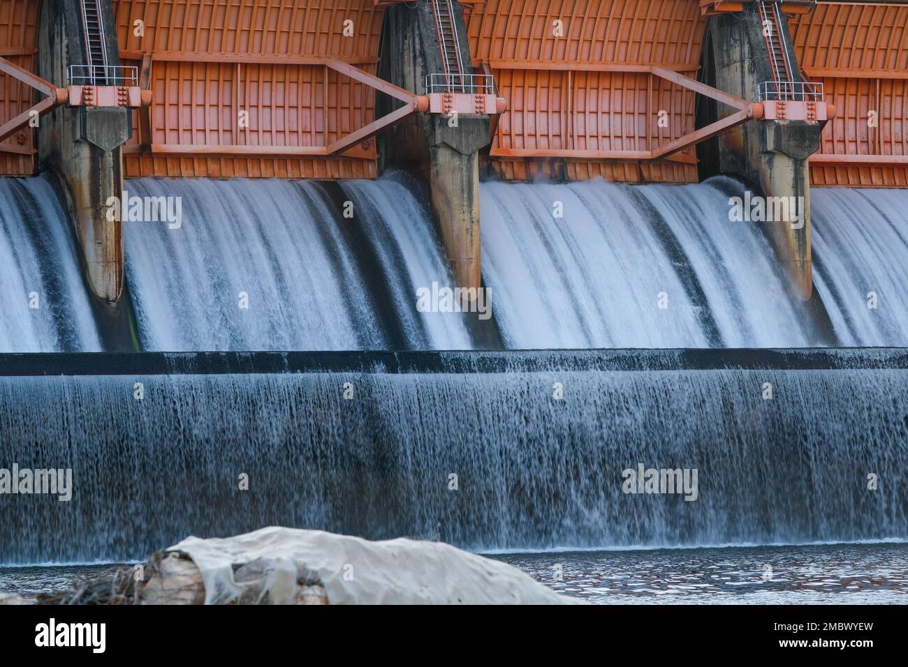 Hydroelectric dam, floodgate with flowing water through gate and open ...