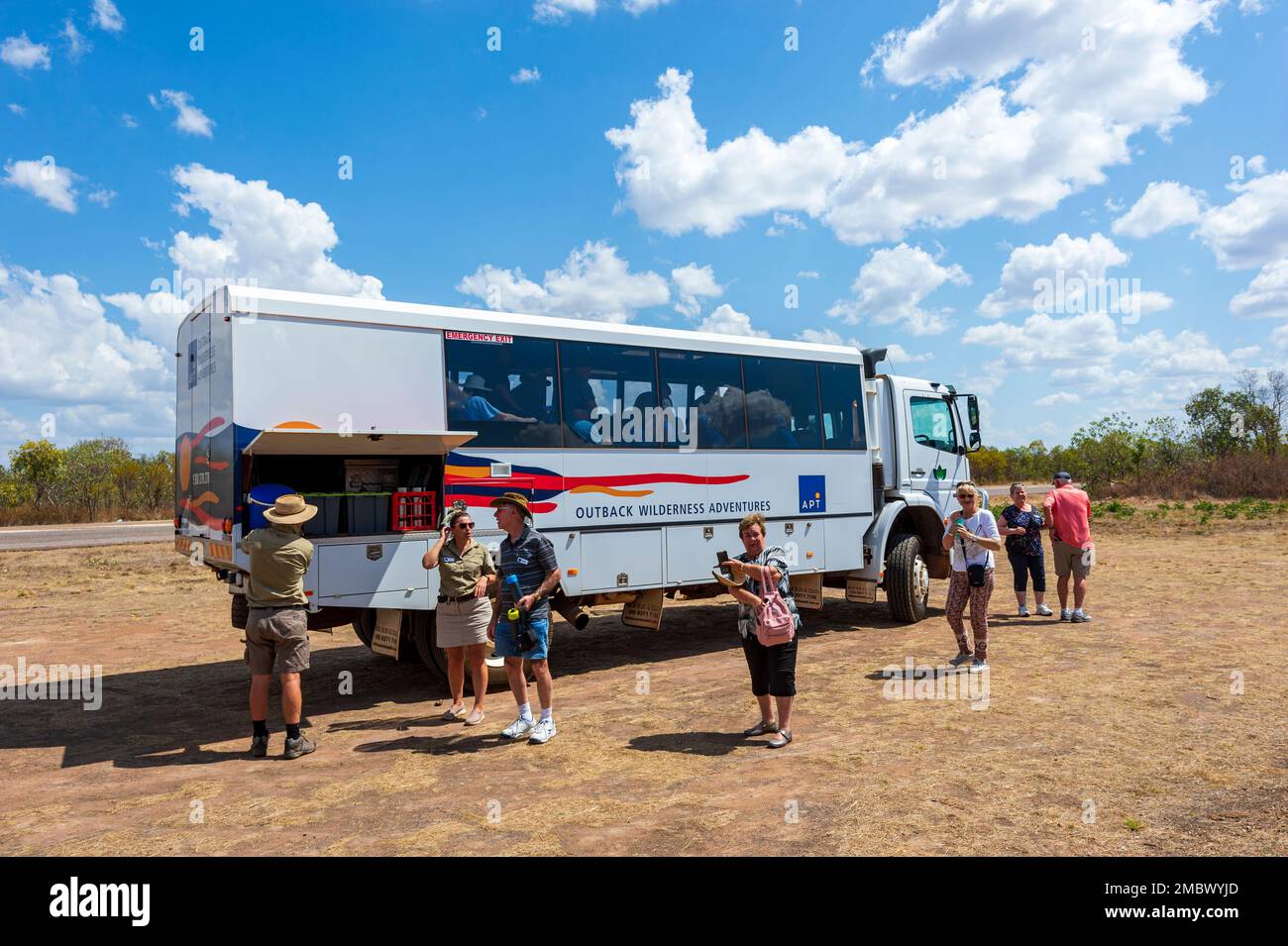 Tourists on a tour with Outback Wilderness Adventures outside a 4WD bus ...