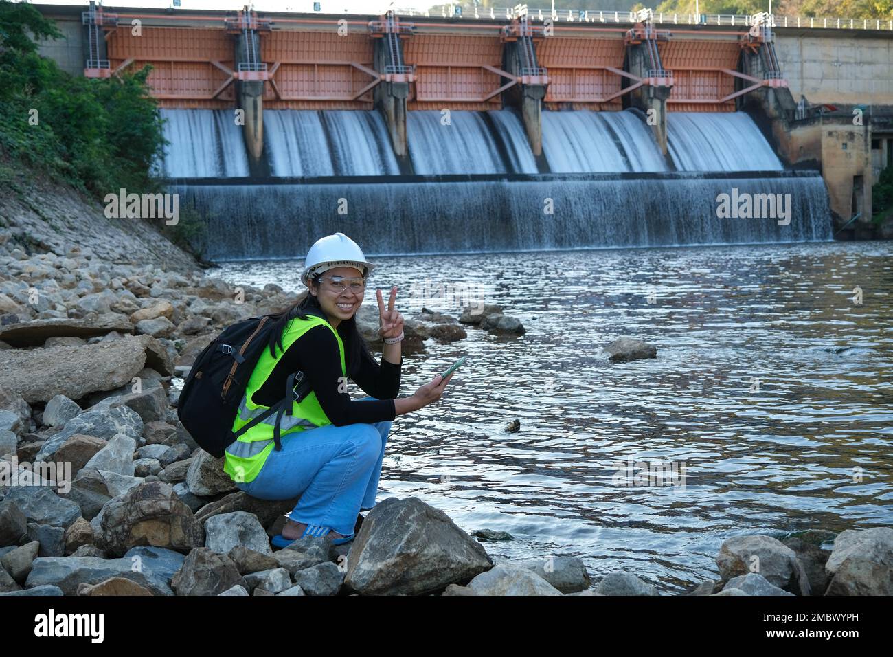 Environmental engineer uses a mobile phone to record water analysis ...