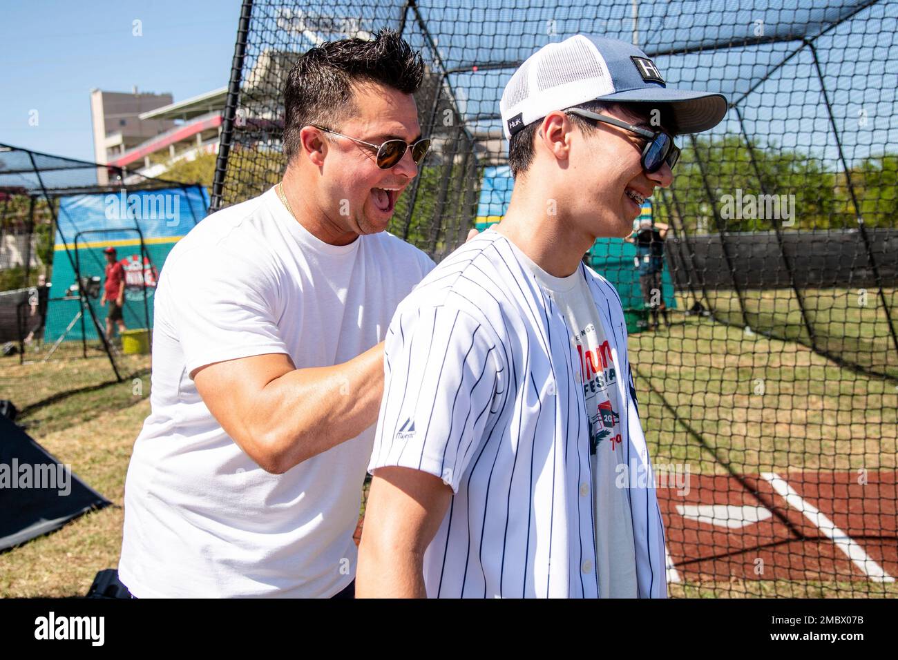 Former Major League baseball player Nick Swisher, left, signs a fan's ...