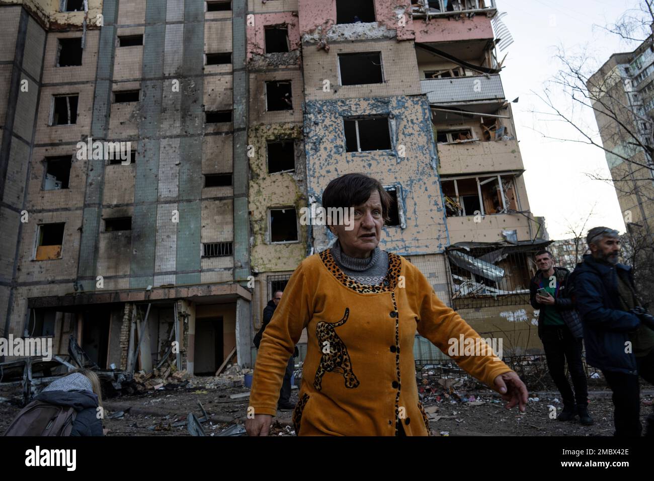 A woman walks out of a heavily damaged building after bombing in Satoya ...