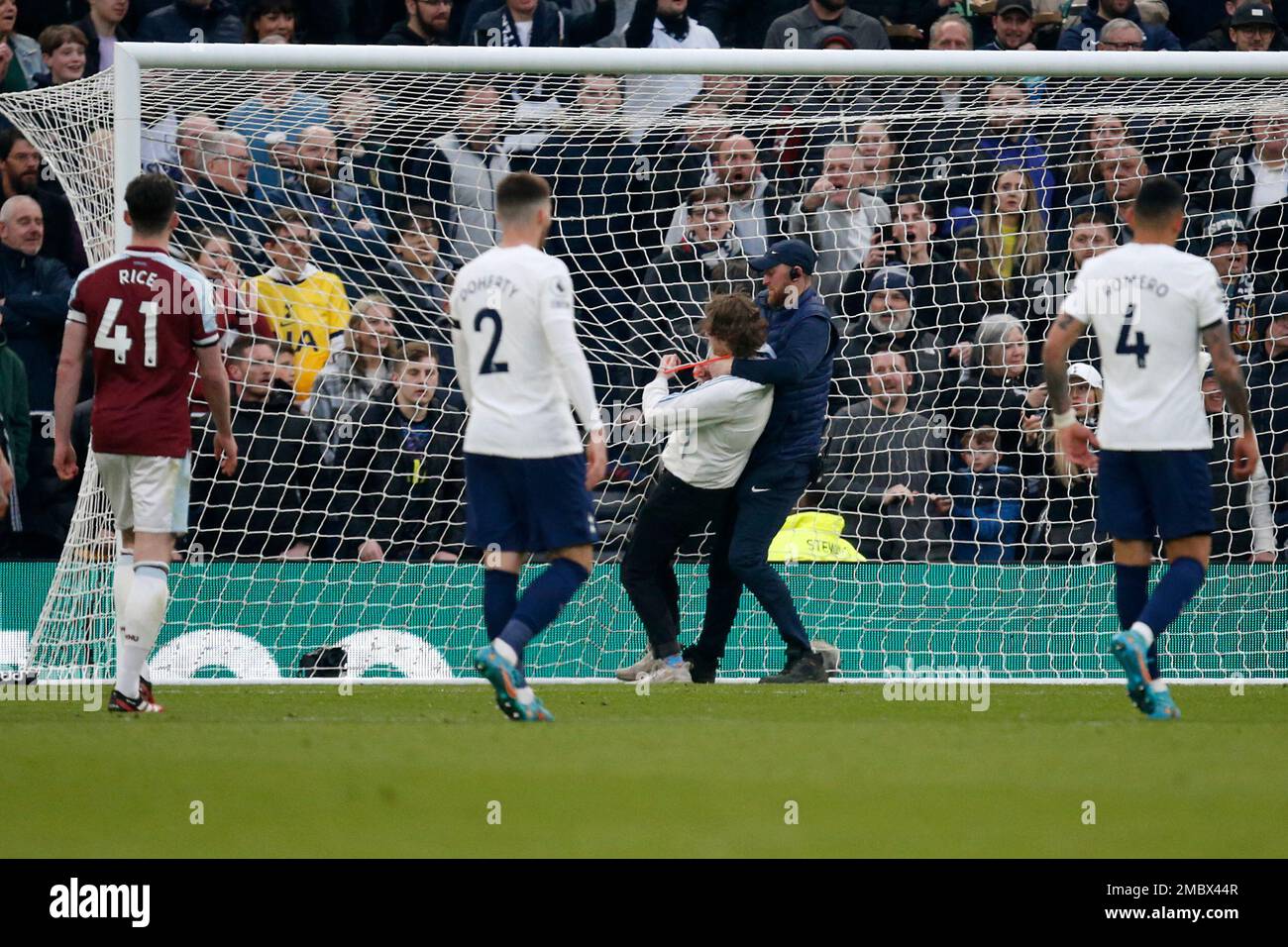 A steward chases a pitch invader during the English Premier League ...