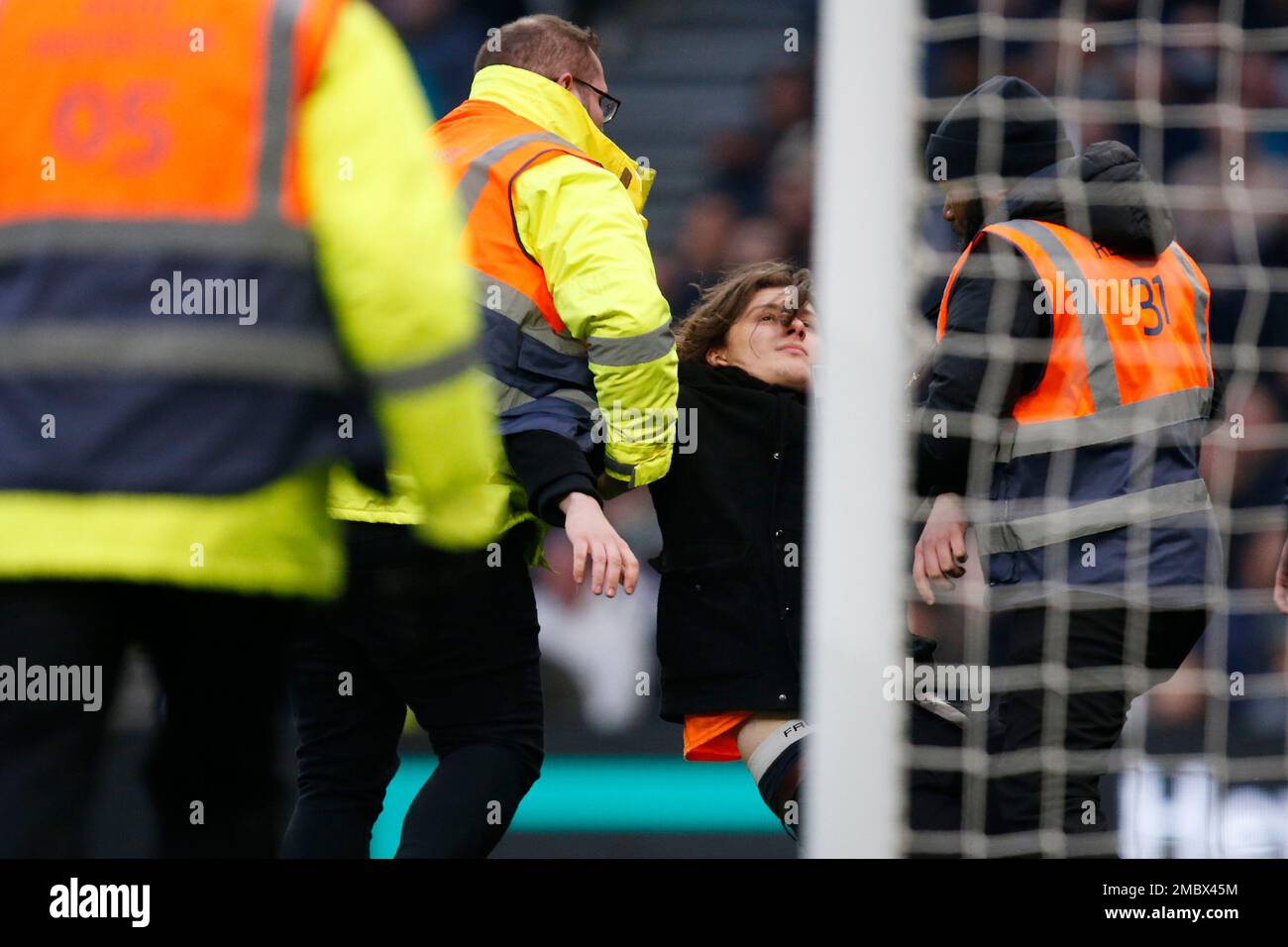 Stewards chase a pitch invader during the English Premier League soccer ...