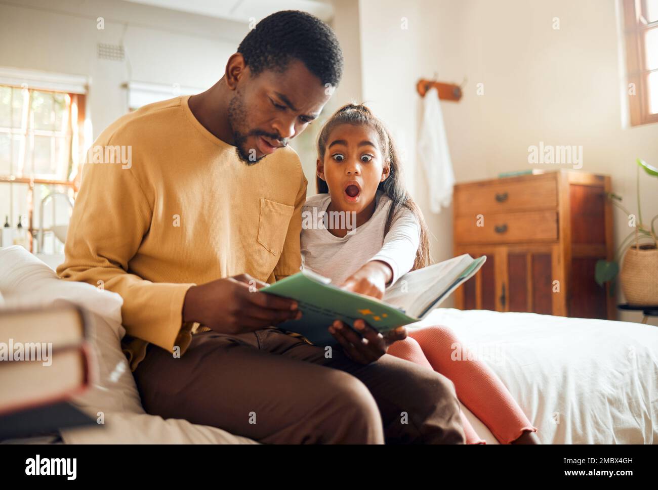 Father, child and book in shock on bed for story time, reading or ...