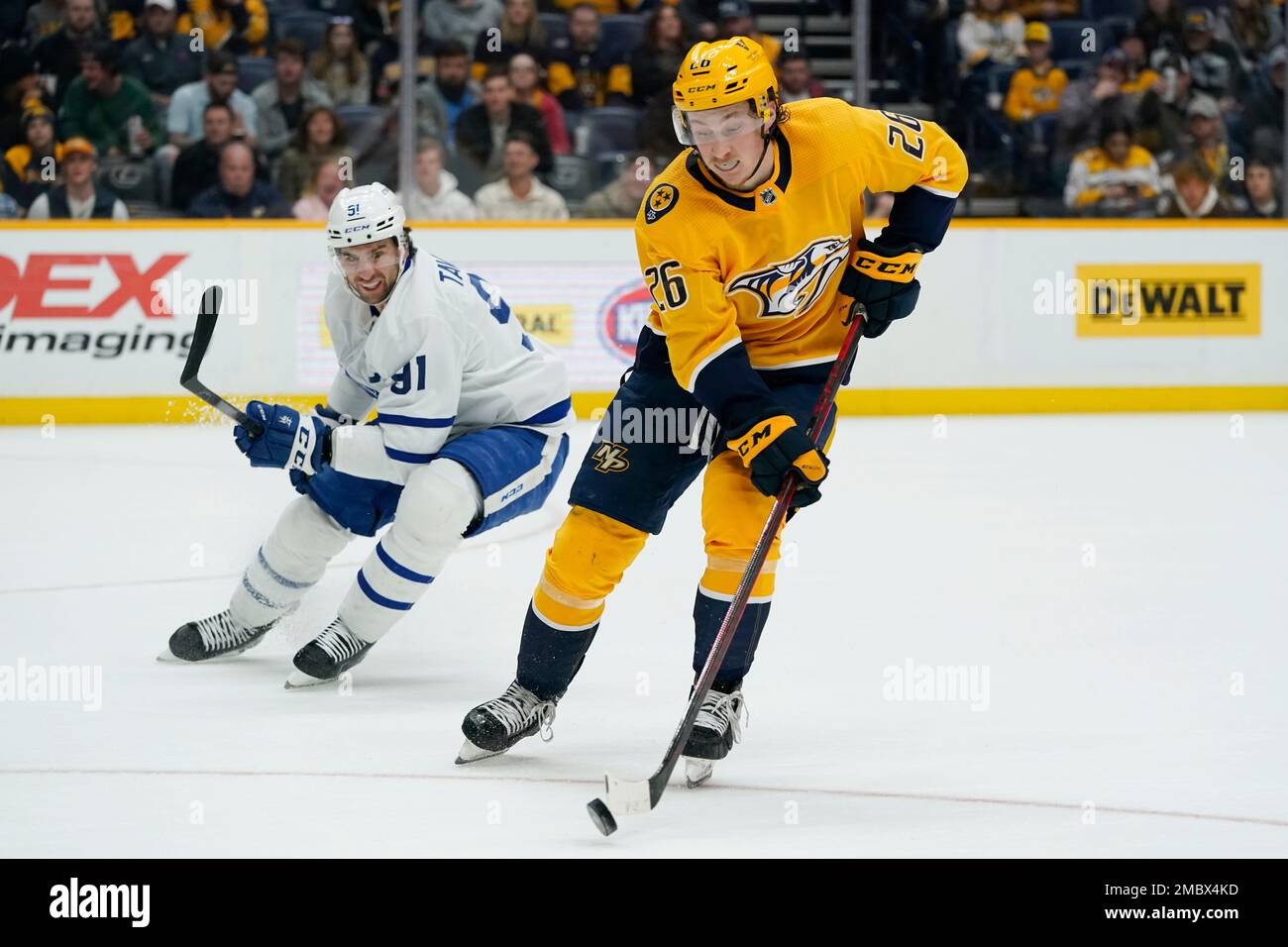 Nashville Predators' Philip Tomasino (26) moves the puck ahead of ...