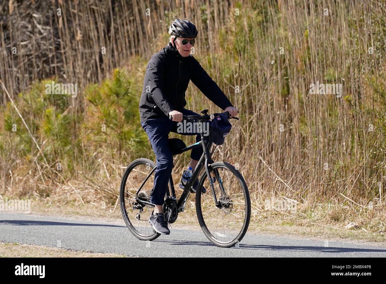 President Joe Biden rides a bicycle in Gordon's Pond State Park in ...