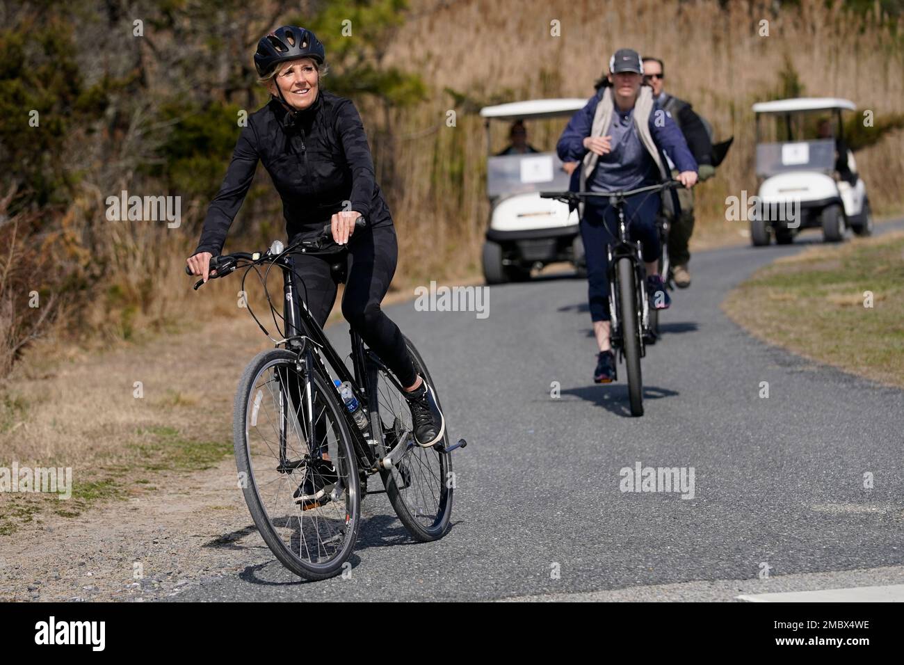 First lady Jill Biden rides a bicycle in Gordon's Pond State Park in ...