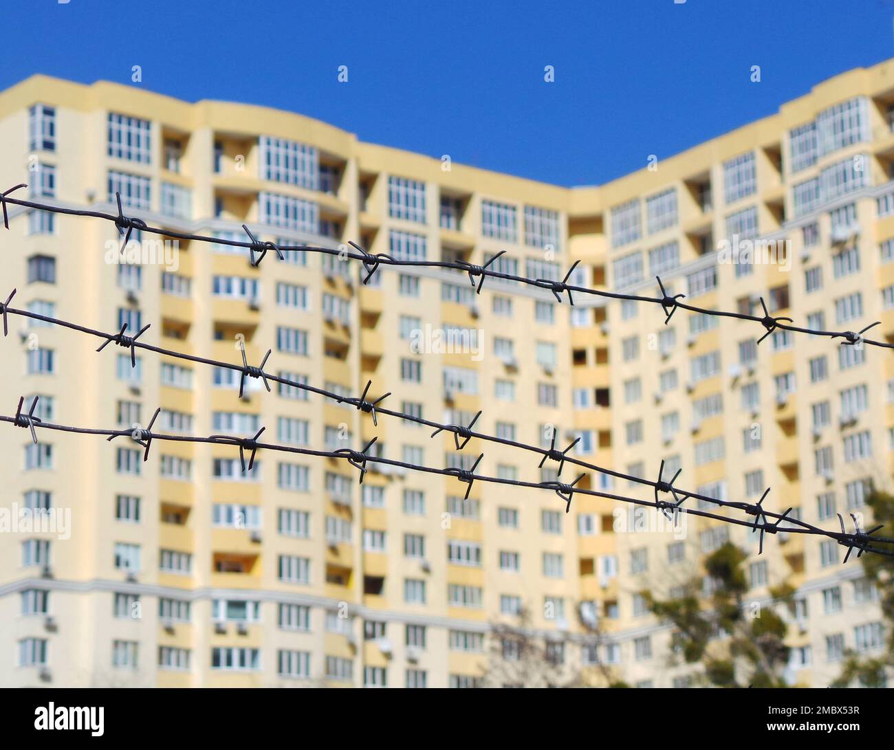 Construction Crysis. Empty High Rise House Behind Razor Wire Stock ...