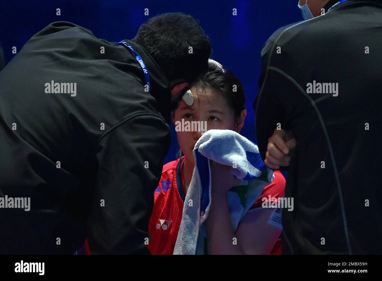 China's Zheng Yu receives medical attention as she and her teammate ...