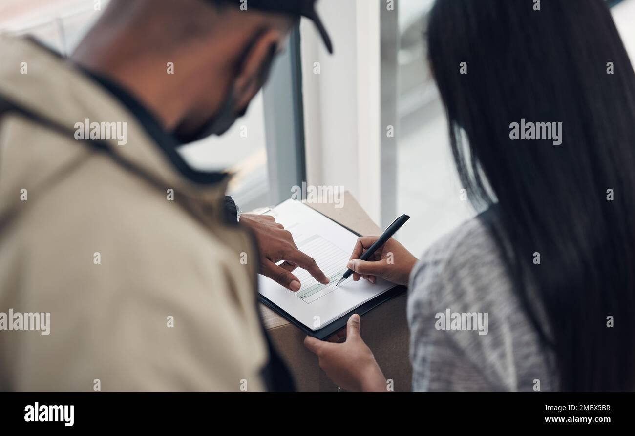 Signing off on another satisfied customer. a woman signing for a ...